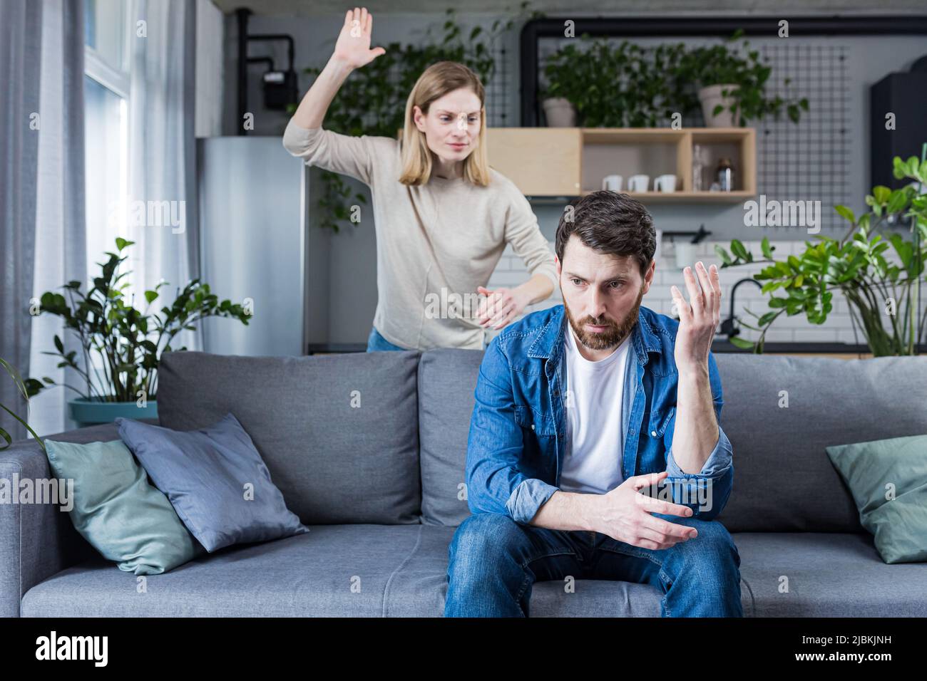 Family quarrel, woman quarrels and yells at the loser's husband, couple ...