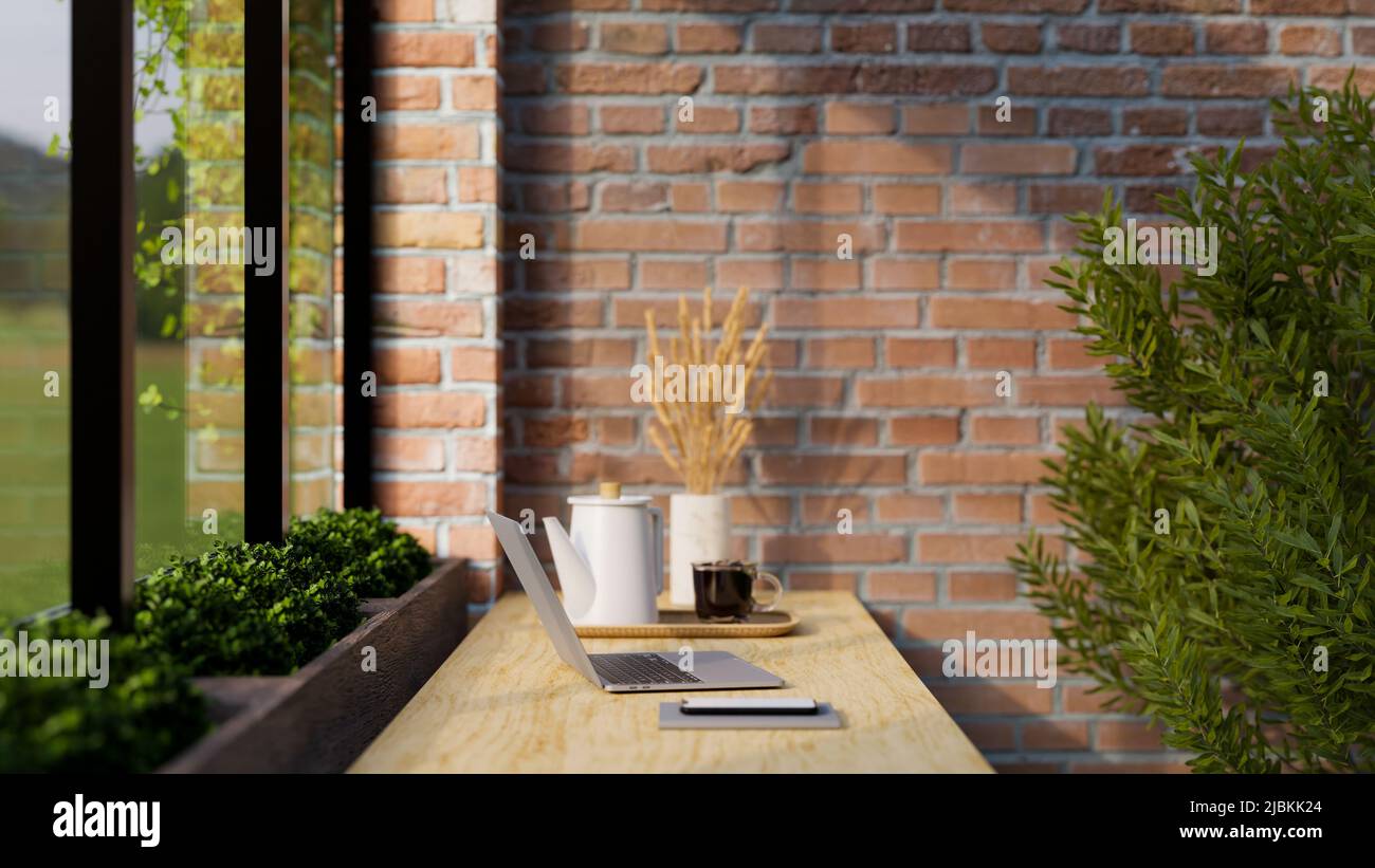 Stylish coffee shop seating area near the window with laptop computer ...