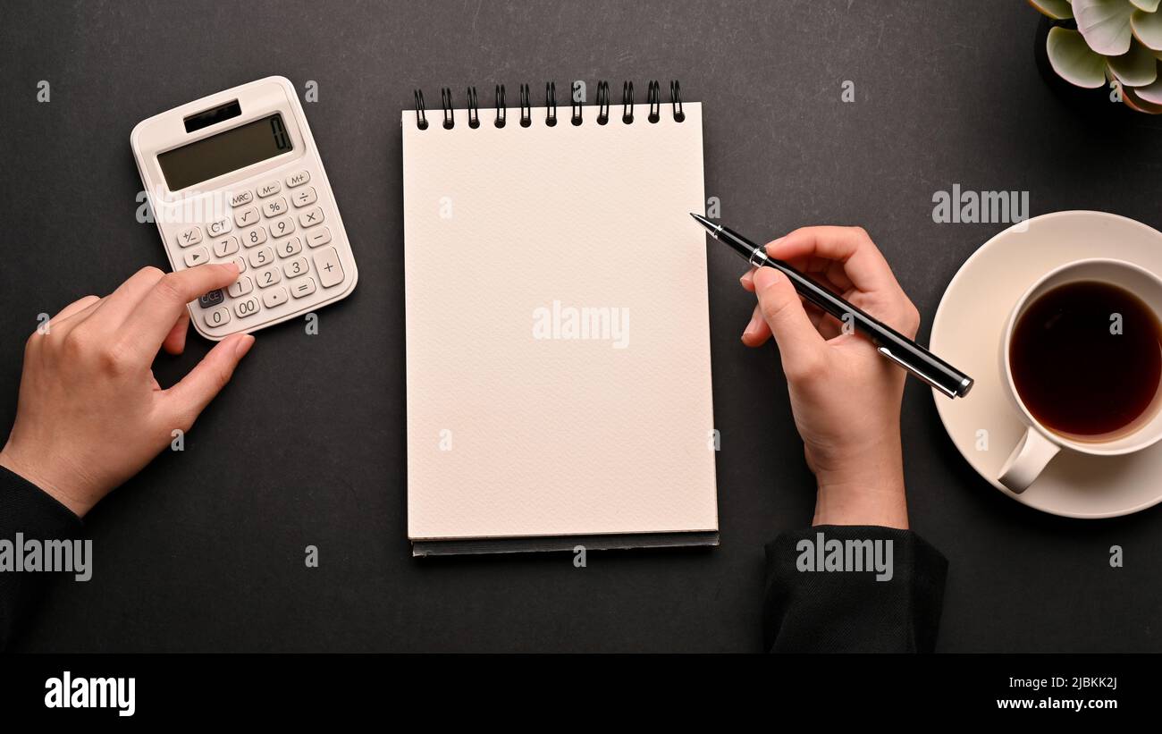 Female accountant calculating a financial income and expenses at her ...