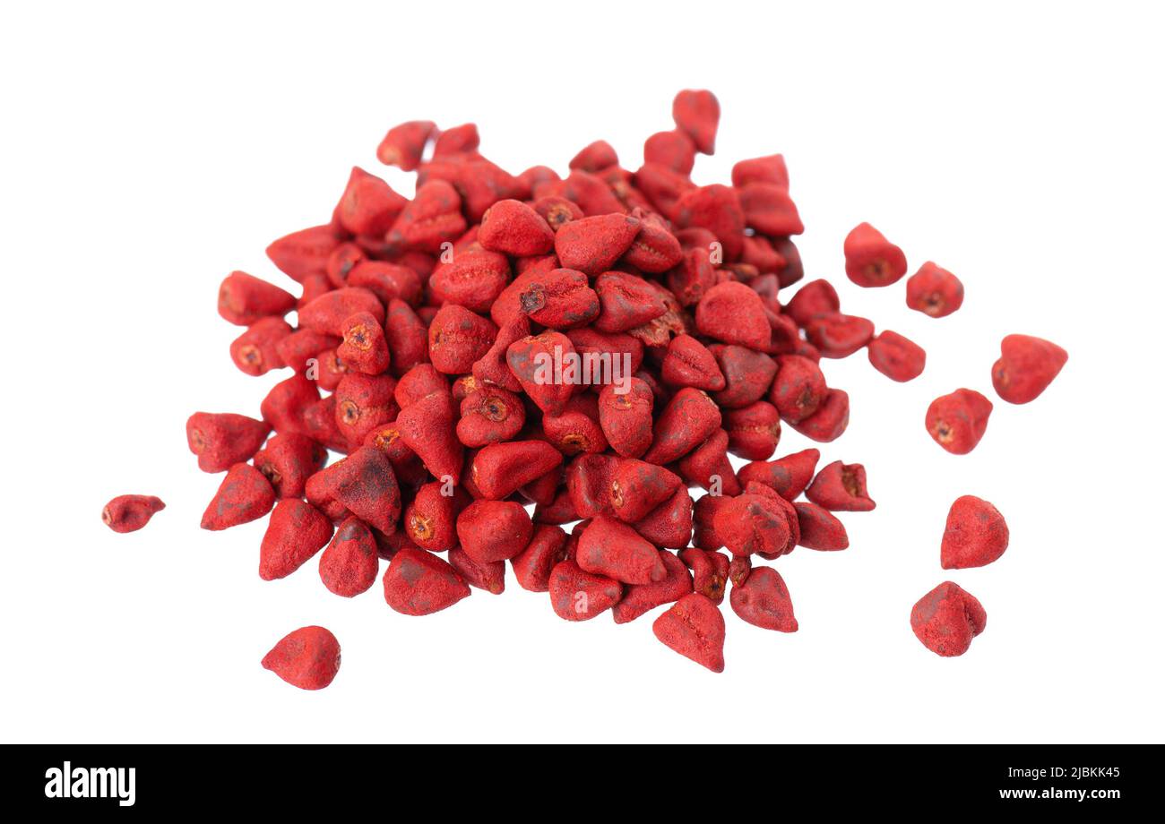 Annatto seeds, isolated on a white background. Achiote seeds, bixa ...