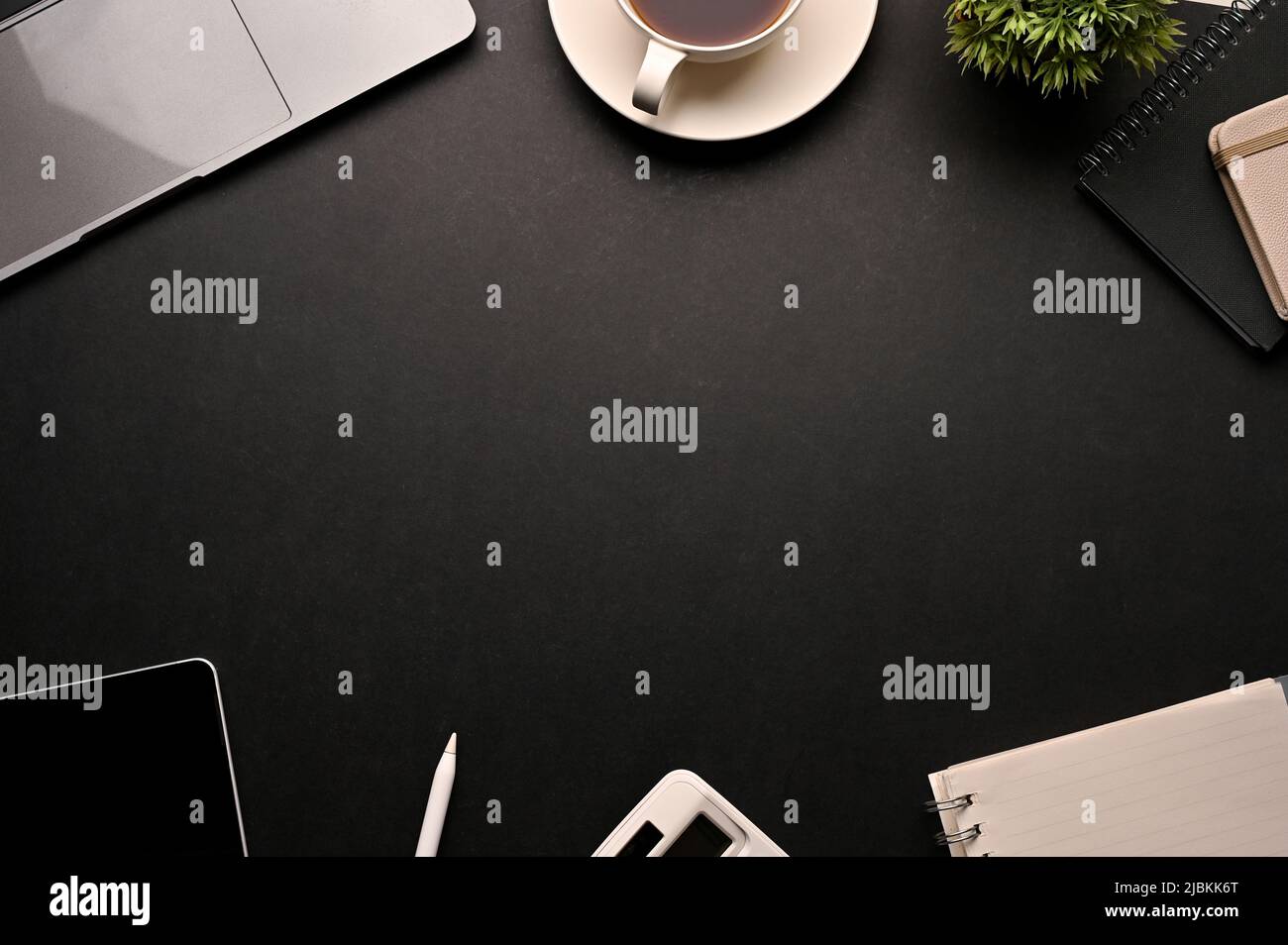 Modern stylish black workspace background surrounded by office objects ...