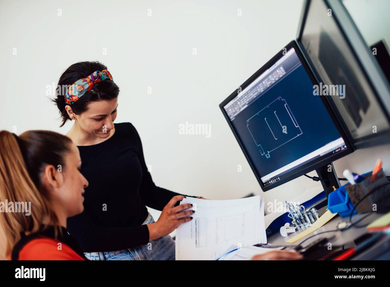 Within the heavy industry, a factory industrial engineer measures with ...