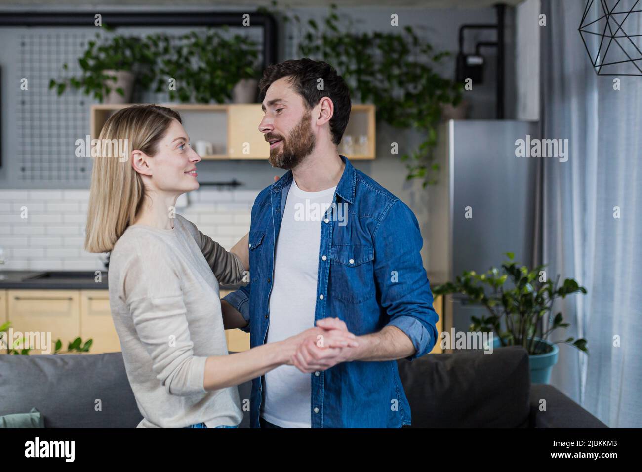 Happy married couple man and woman dancing together at home in the ...