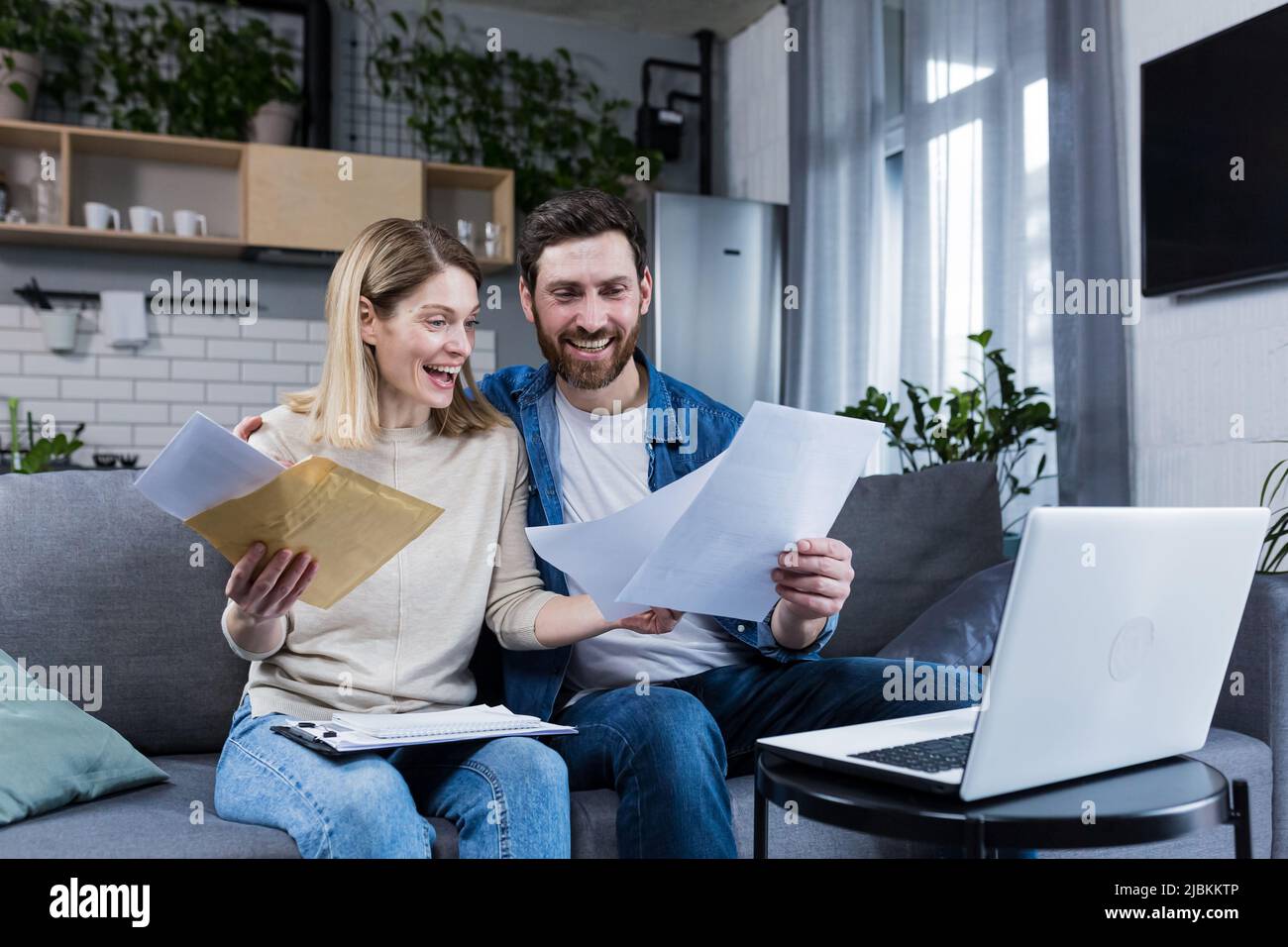 Happy married couple, man and woman, received a positive letter ...