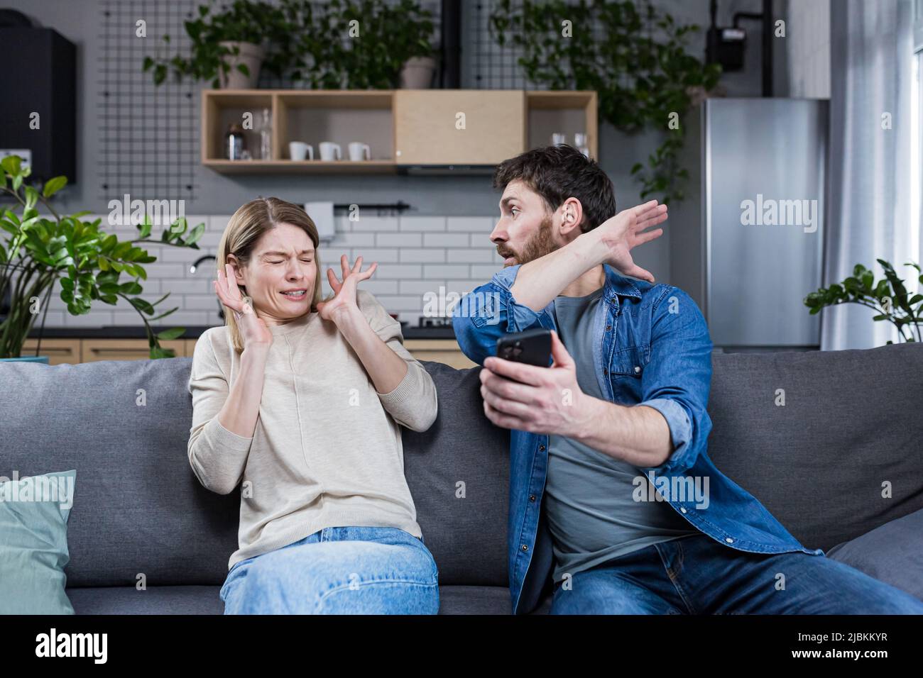 jealous man shouting at woman over the phone, married couple quarreling ...