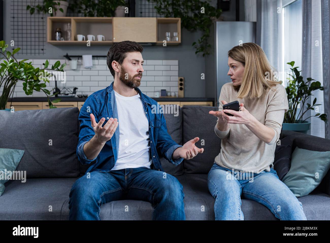 Conflict, quarrel, jealousy in the family home. Young couple, man and ...