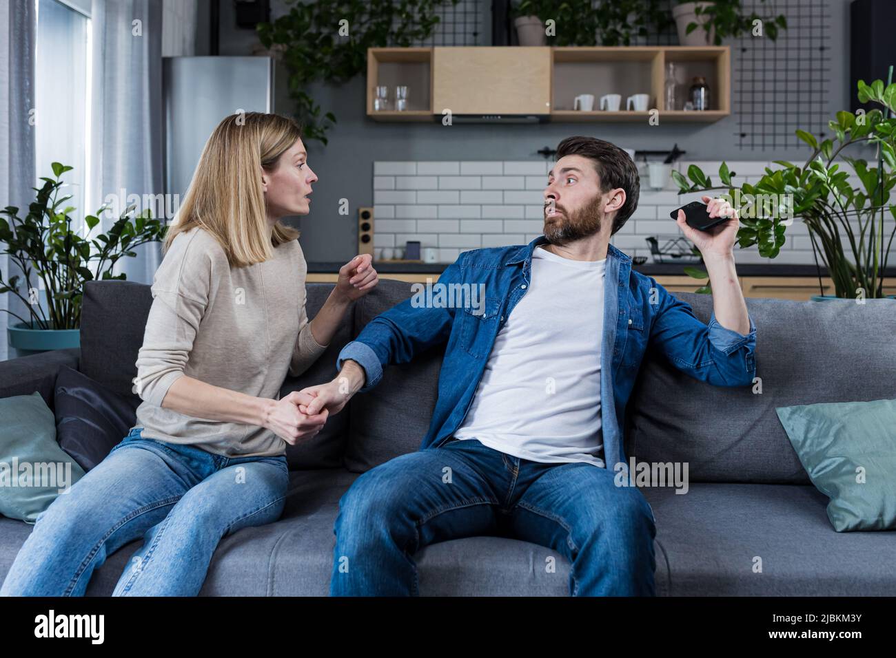 Conflict, quarrel, jealousy in the family home. Young couple, man and ...