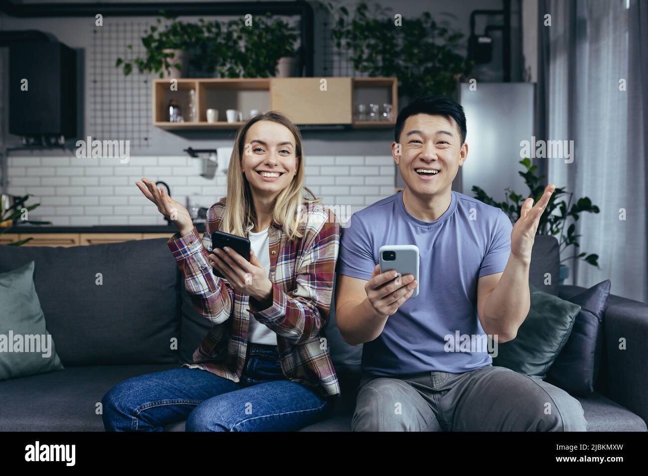 Man and woman young family together looking at camera and smiling ...