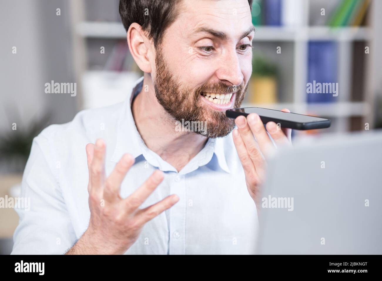 Aggressive man records voice message hi-res stock photography and ...