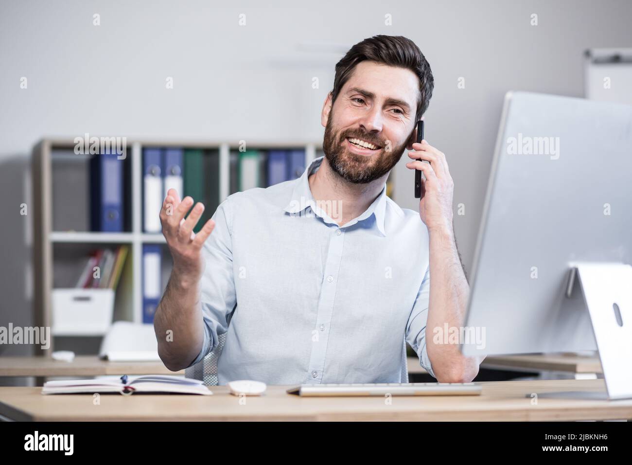 Successful male programmer working in the office at the computer ...