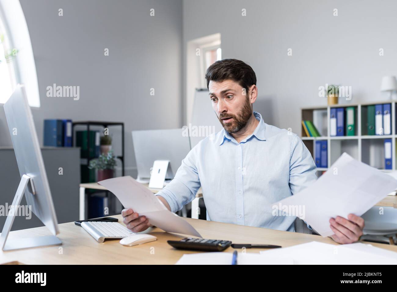 Frustrated businessman holds documents hi-res stock photography and ...