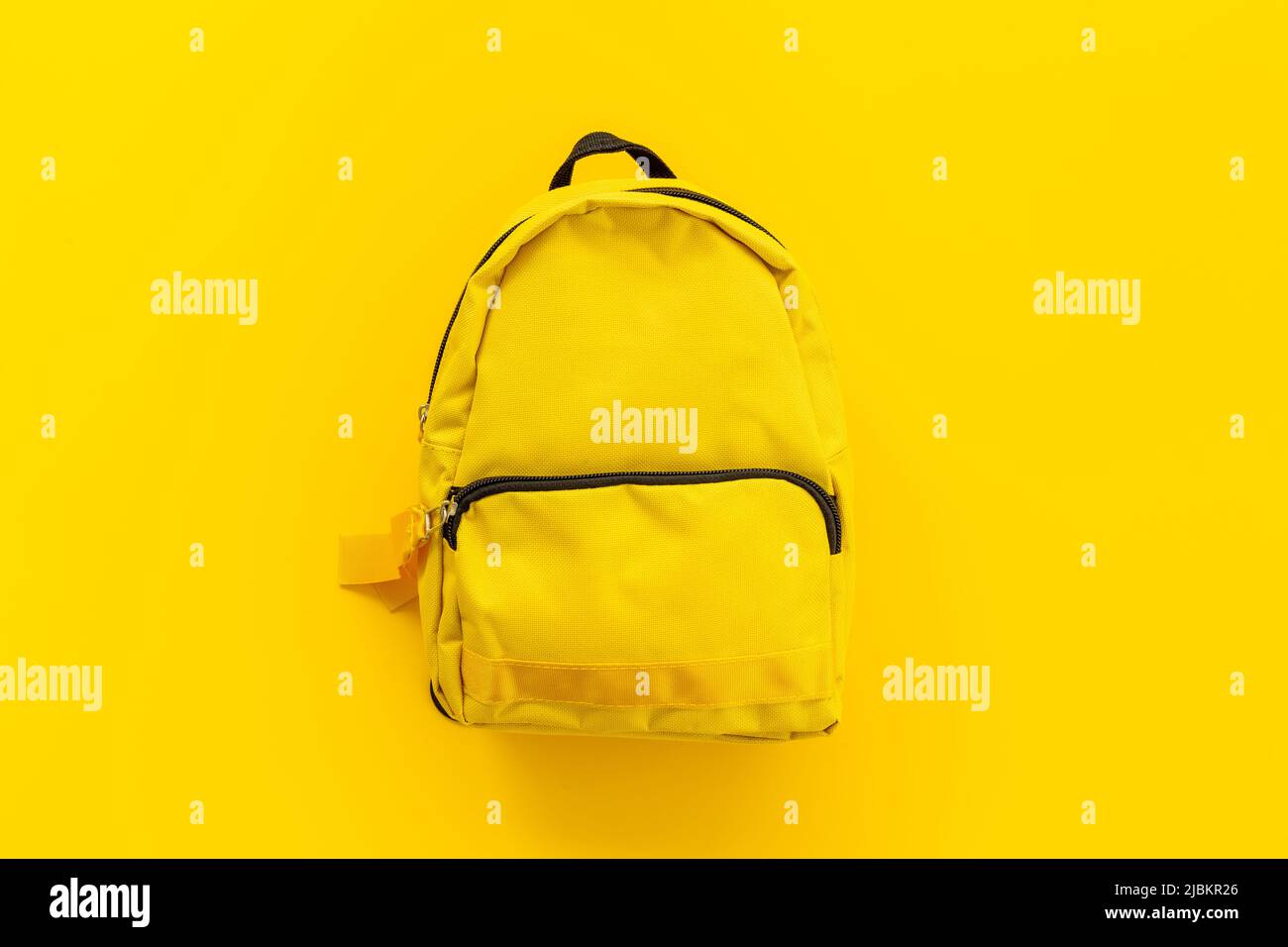 Classic yellow school backpack top view. Educational objects background ...