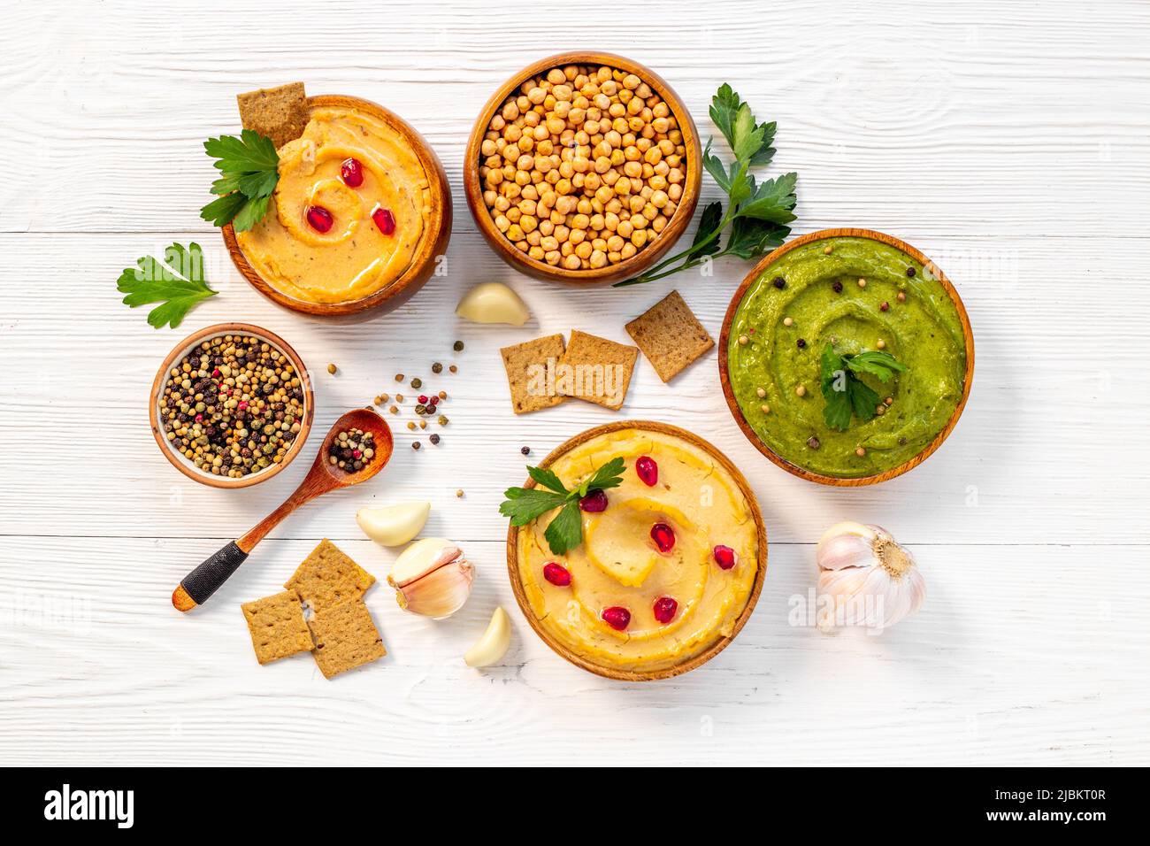 Flatlay of different types of colorful hummus in bowls. Vegan food ...