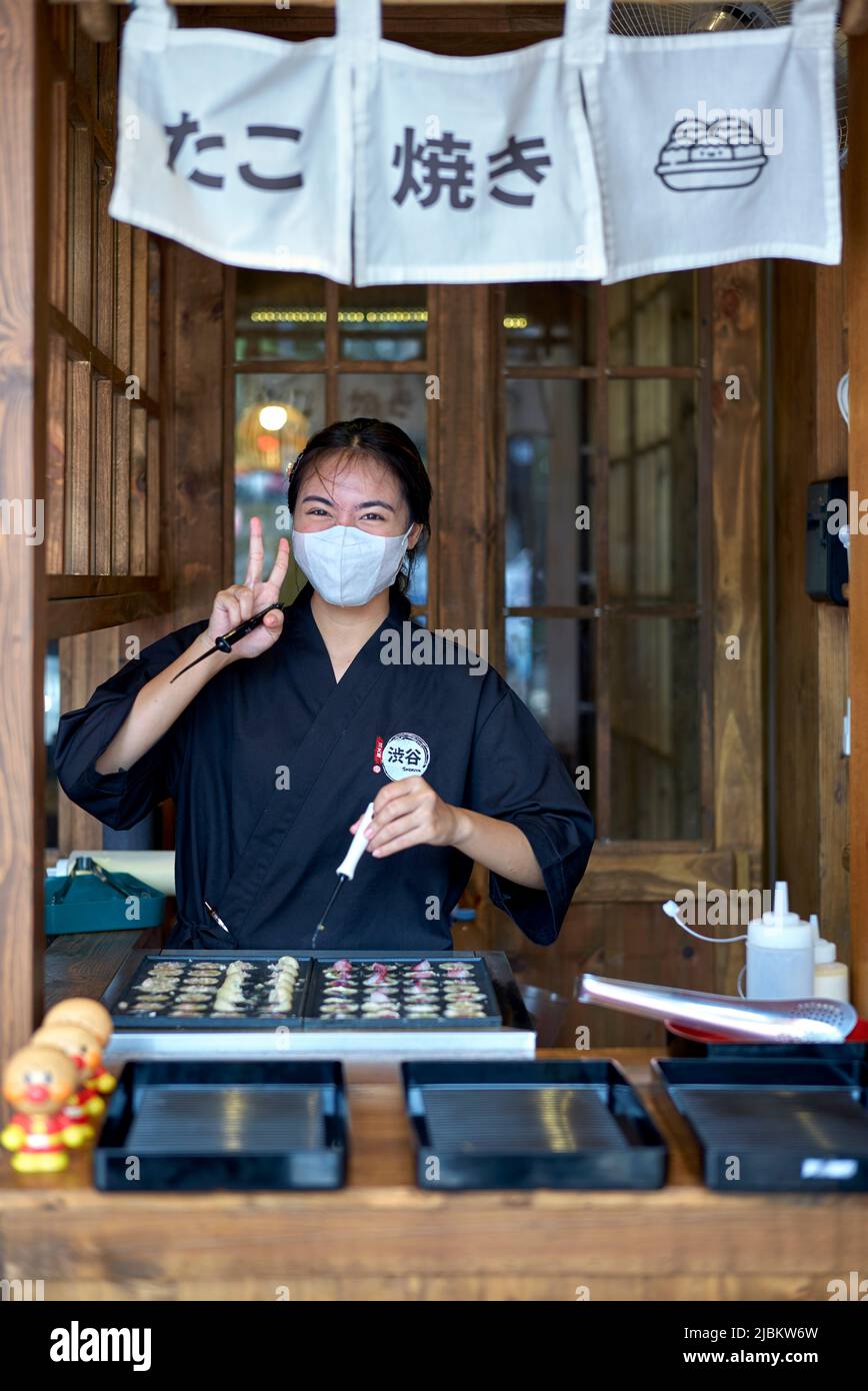Female chef in a Japanese restaurant cooking traditional Japanese ...