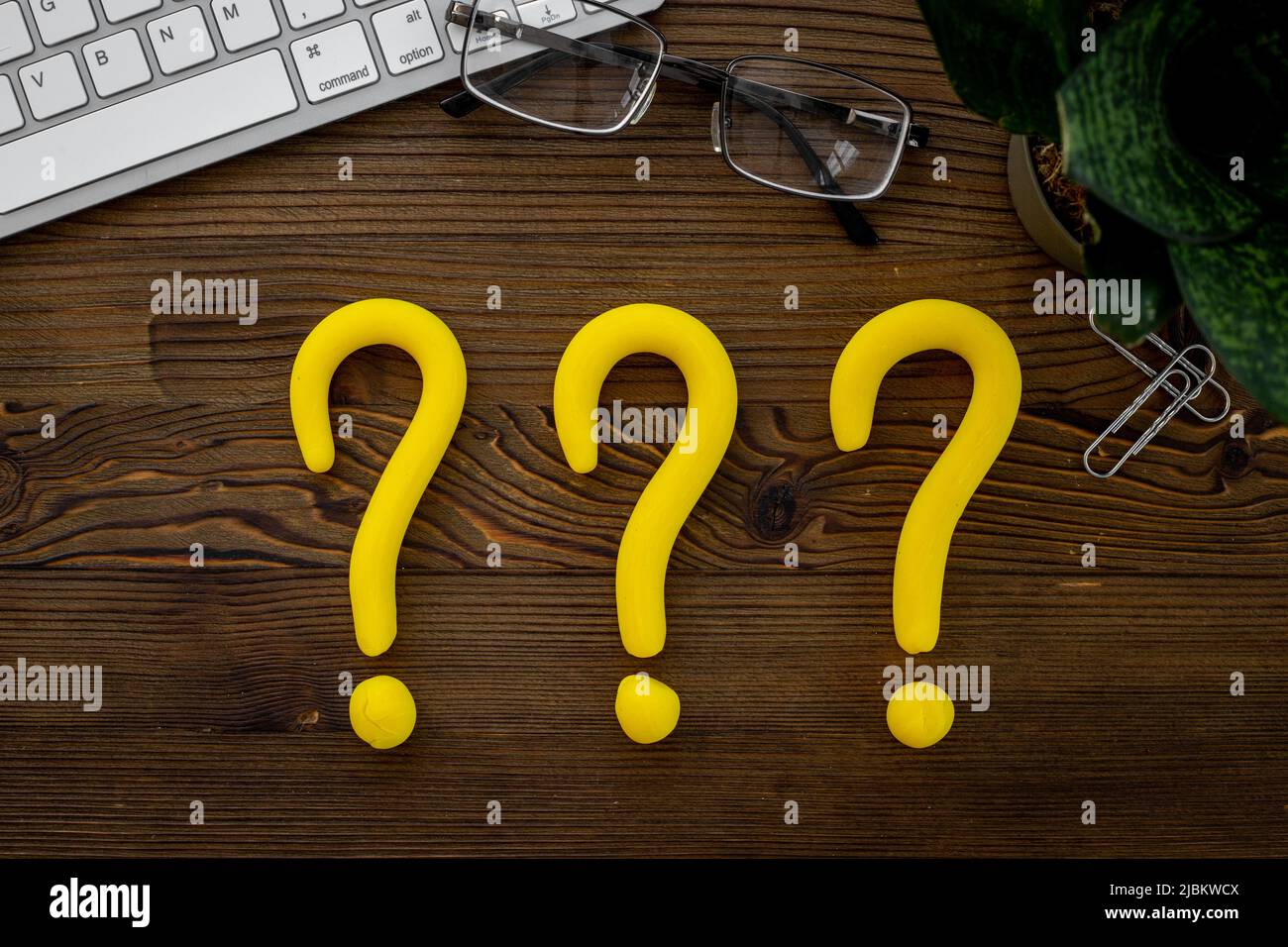 Question mark signs on office table. Customer support servise or FAQ ...