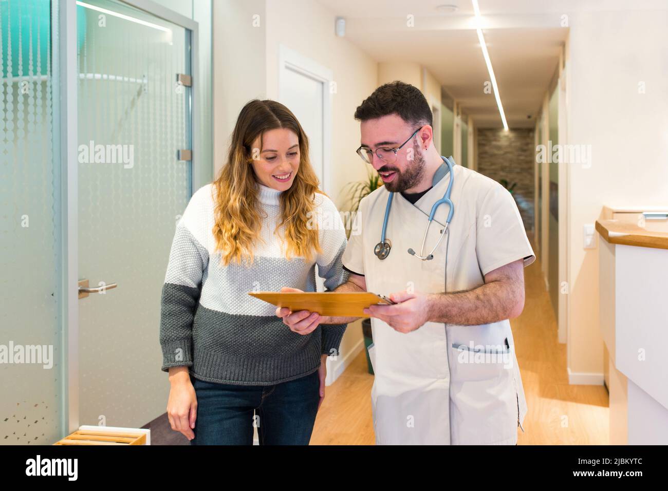 Male doctor talking to female patient that being treated at the medical ...