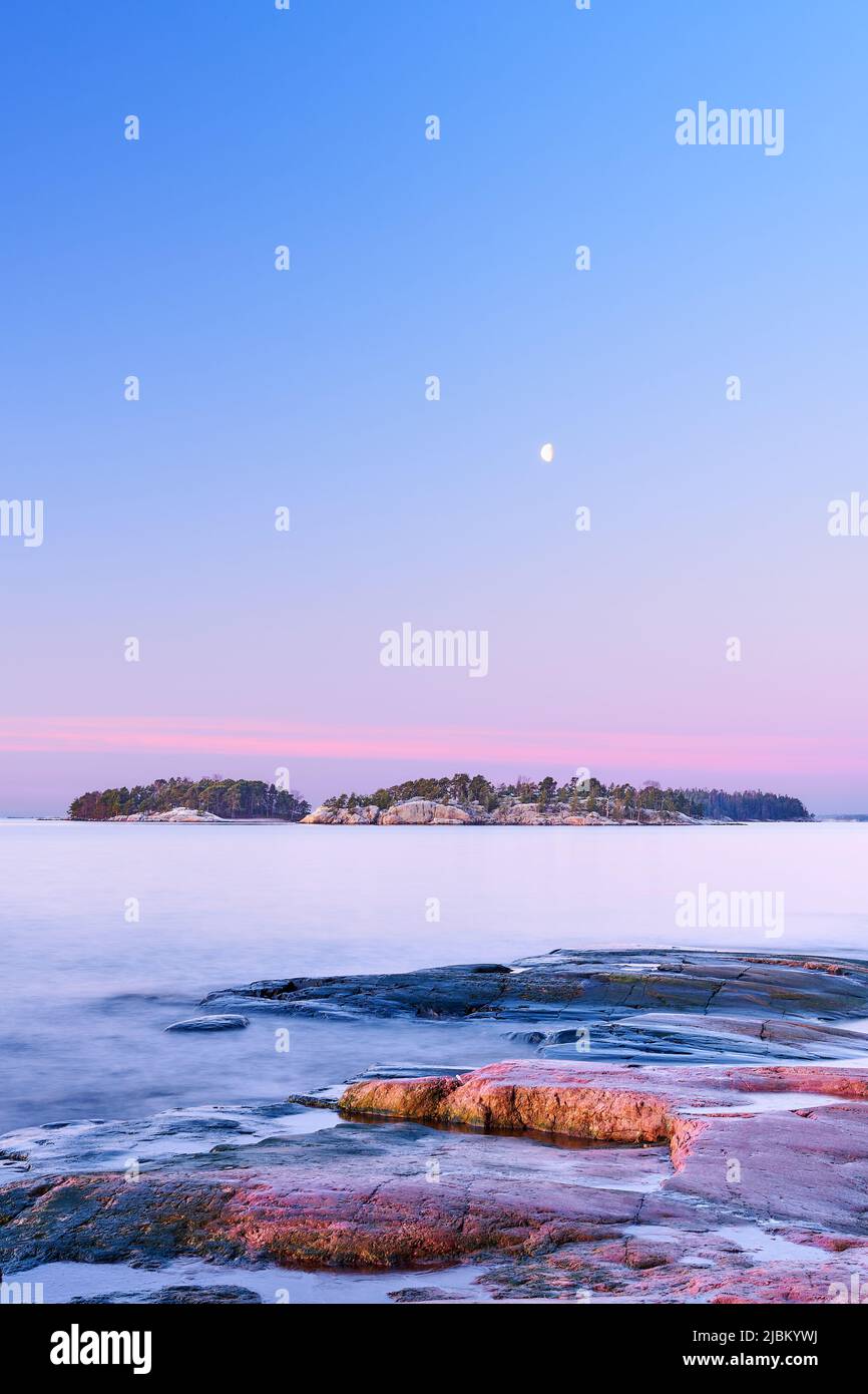 Moon over an island near Helsinki during sunrise Stock Photo - Alamy