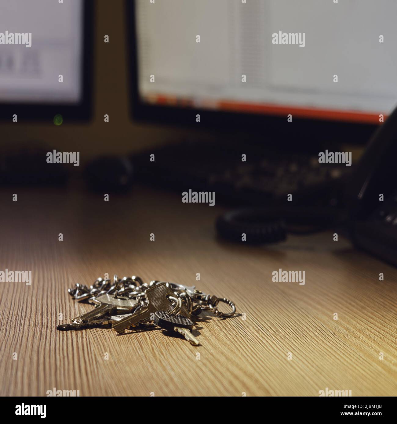 A bunch of keys to the room lies on an office desk with computer ...