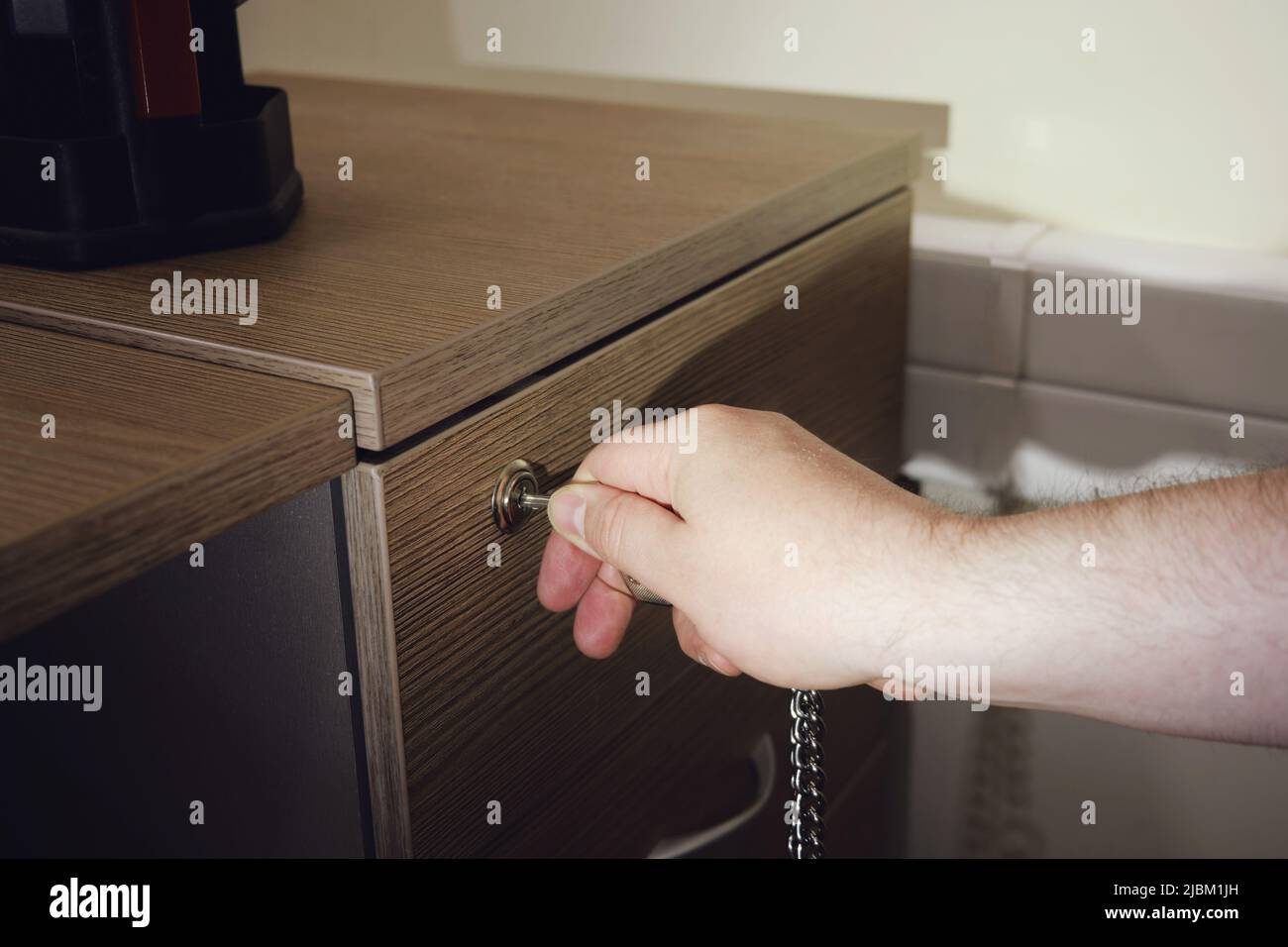 Man hand opens the office desk drawer, close up Stock Photo - Alamy