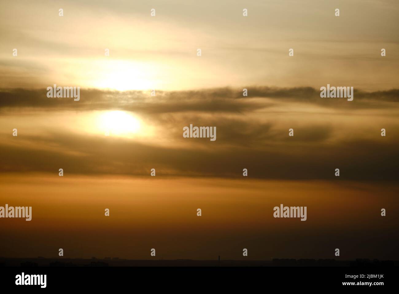 Evening dramatic sky with clouds during sunset. The sun sets behind ...