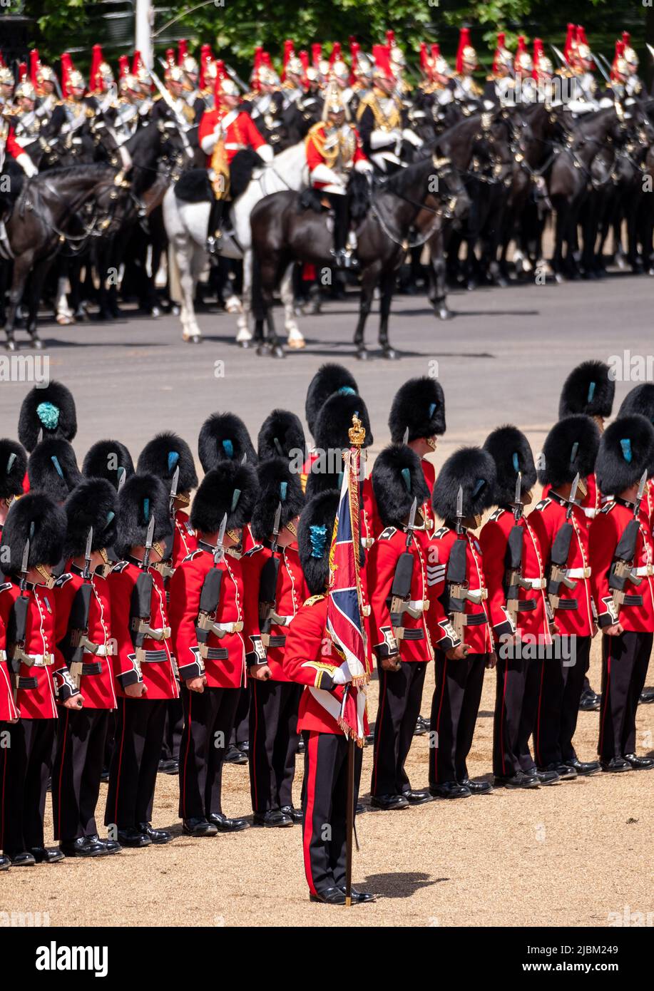 Uniformed guardsmen and women in black and red marching at Horseguards ...