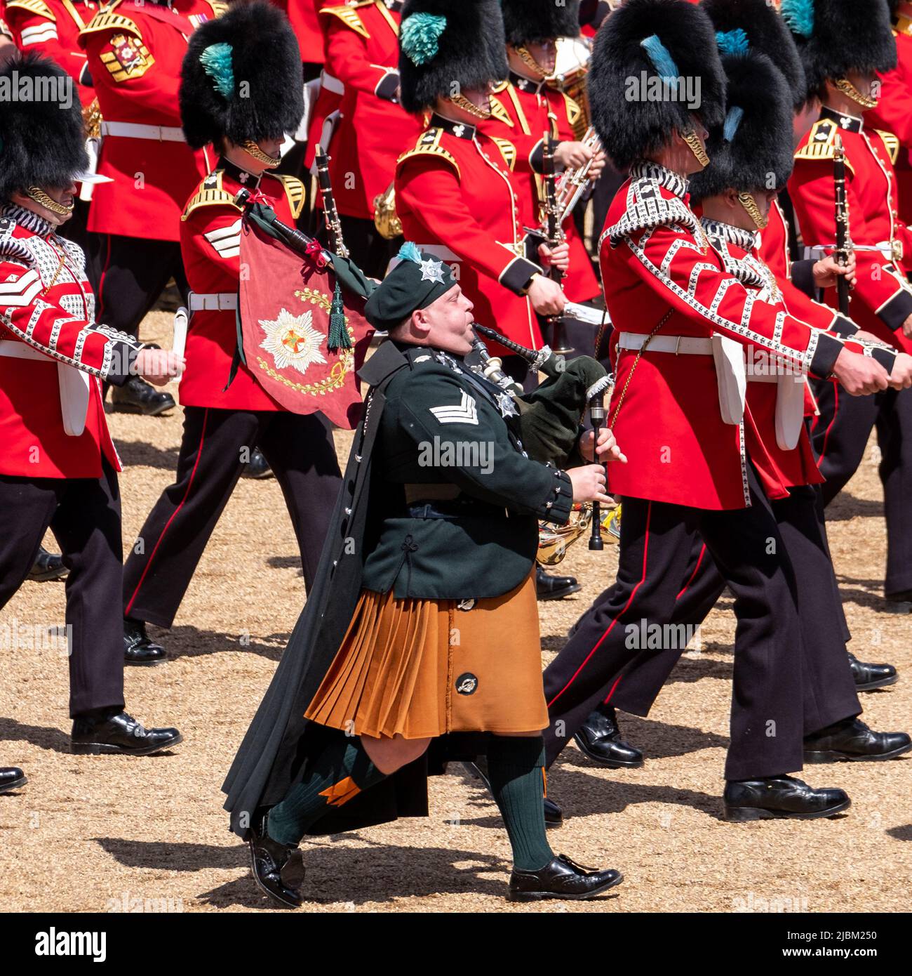 Uniformed guardsmen and women in black and red marching at Horseguards ...