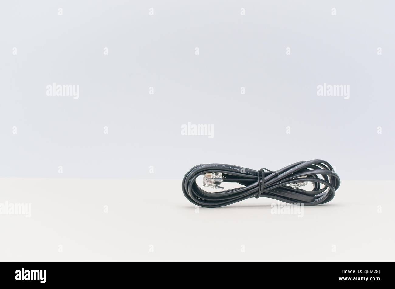 isolated data cable with RJ11 phone modem connector on a soft white ...