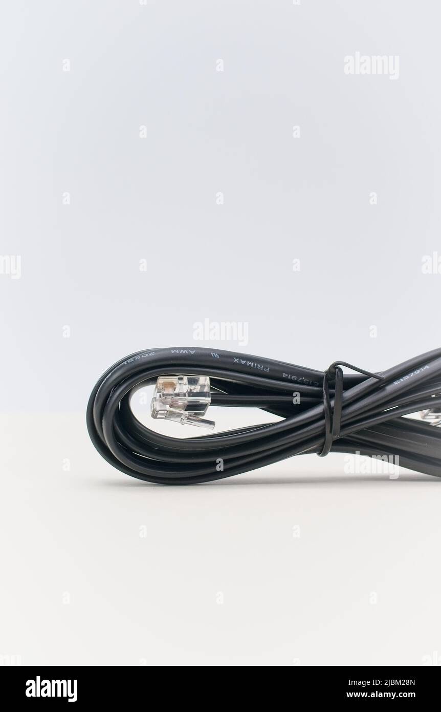 isolated data cable with RJ11 phone modem connector on a soft white ...