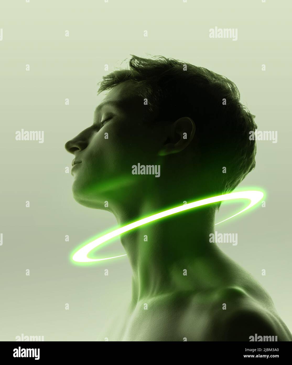 Contemporary design. Young sad man with neon circle around his neck ...
