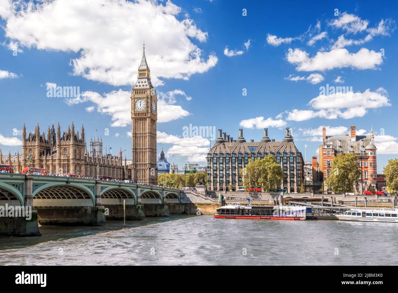 Famous Big Ben with bridge over Thames and tourboat on the river in ...