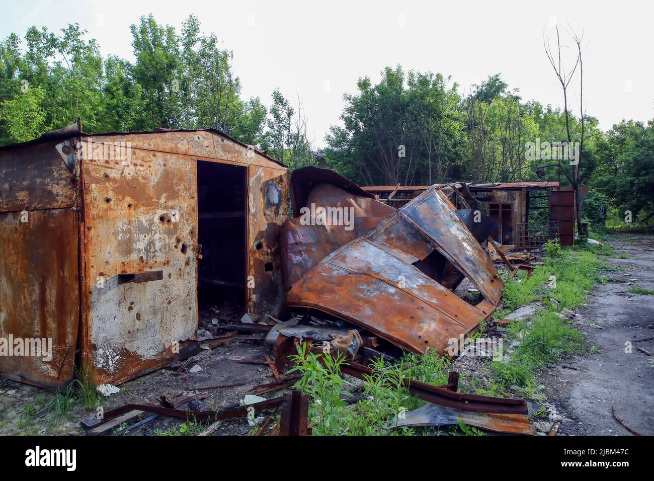 KYIV REGION, UKRAINE - JUNE 4, 2022 - Burnt-out metal construction are ...