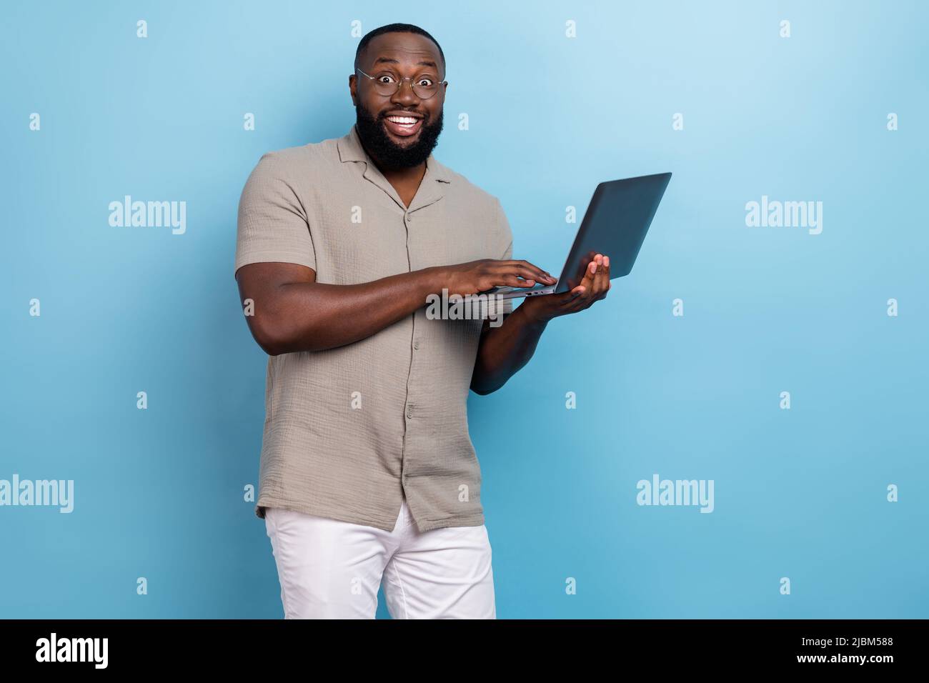 Portrait of cheerful positive person hold use wireless netbook toothy ...