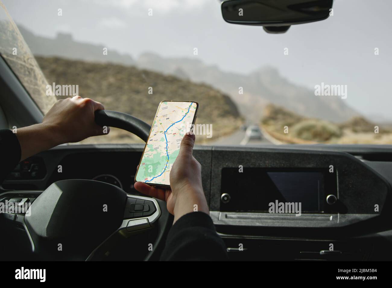 Driving a car using the navigation on a smartphone. Mockup with blank ...