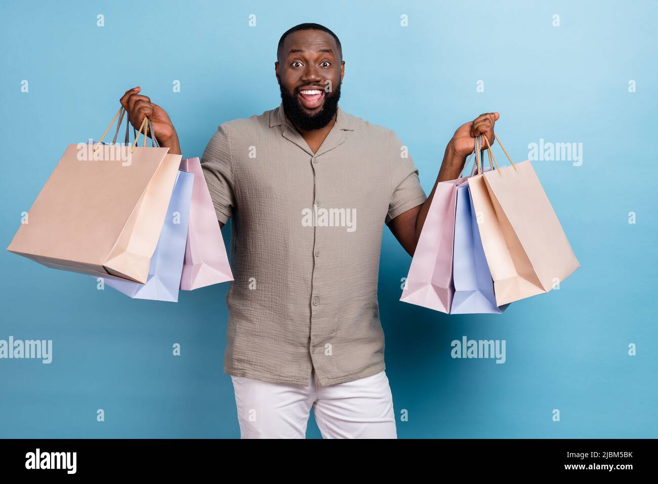 Portrait of overjoyed positive person impressed face hold boutique ...