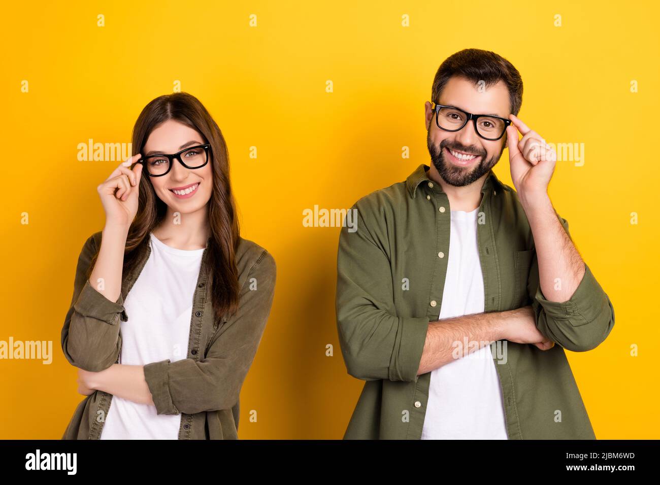 Photo of positive cheerful colleagues in spectacles working together on ...