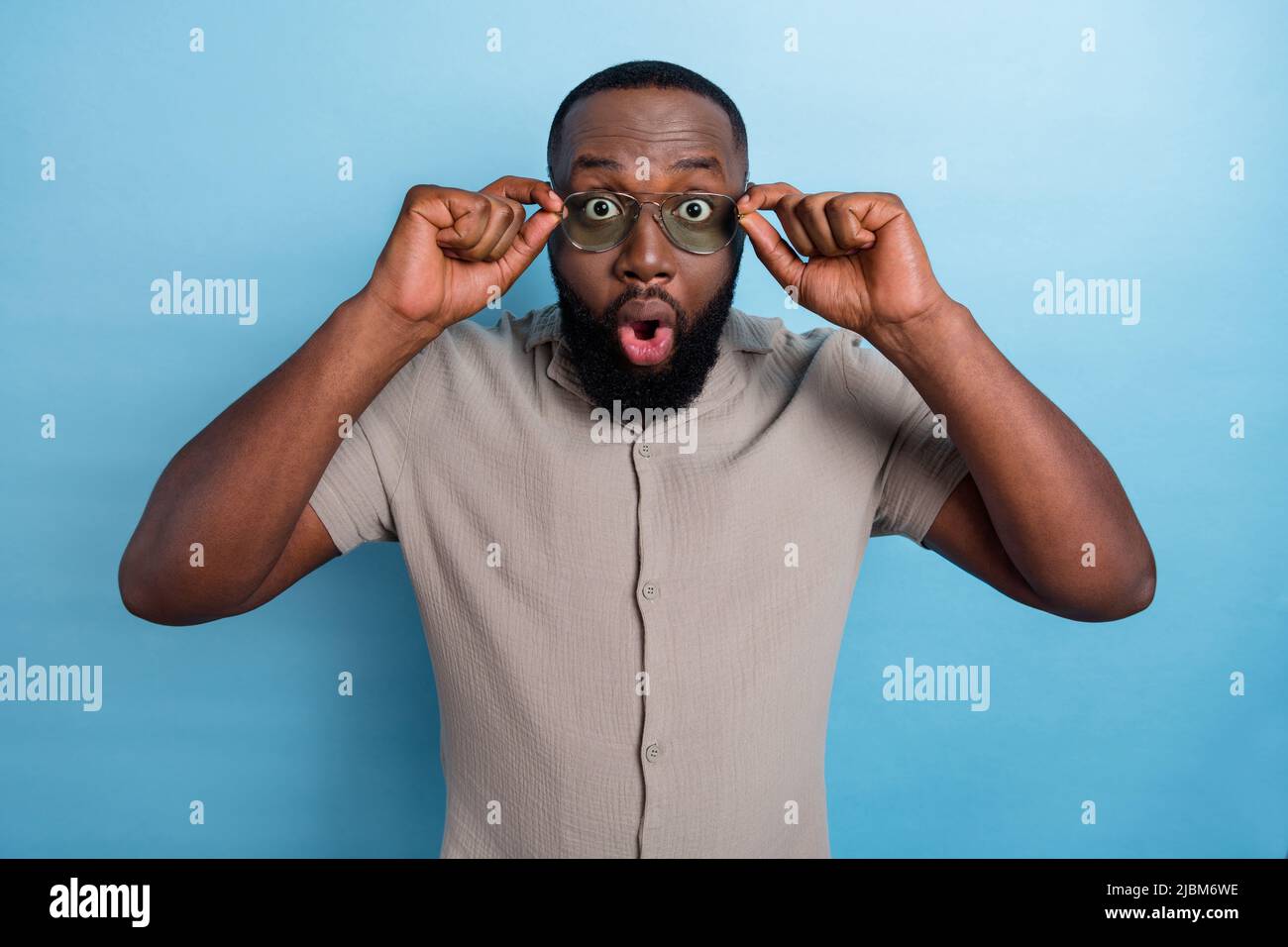 Portrait of impressed confused person arms touch glasses pouted lips ...