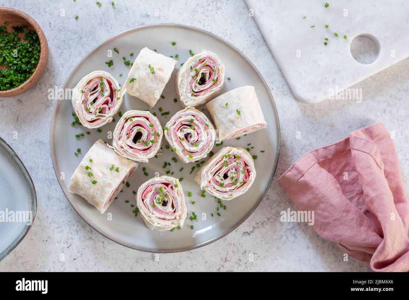 Ham and cream cheese rolled up in a tortilla Stock Photo - Alamy