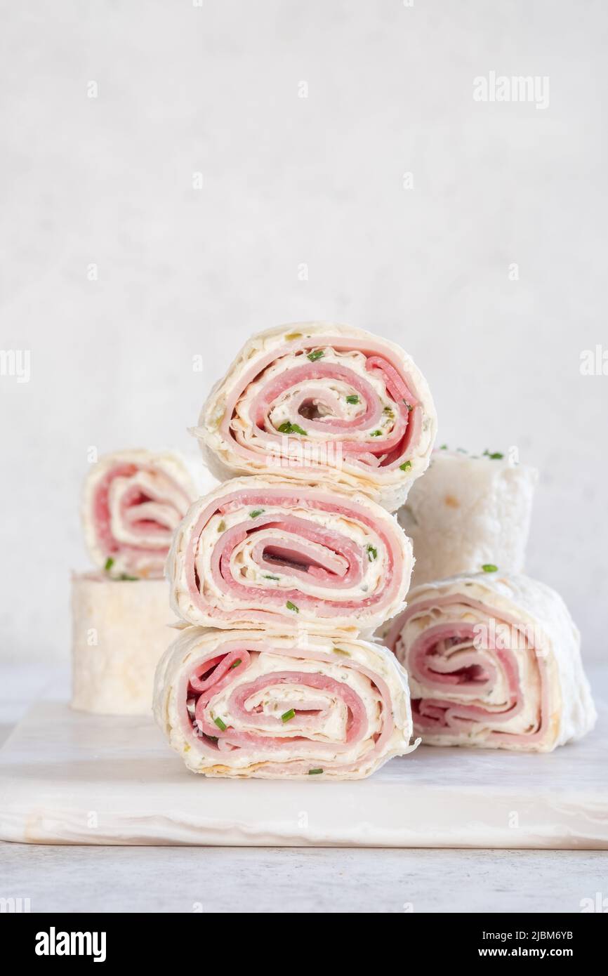 Ham and cream cheese rolled up in a tortilla Stock Photo - Alamy
