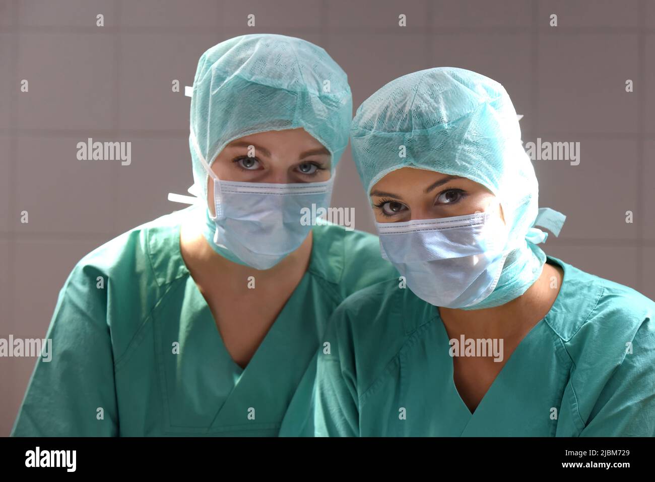 Two young women are seen in an operation theater dressed with medical ...