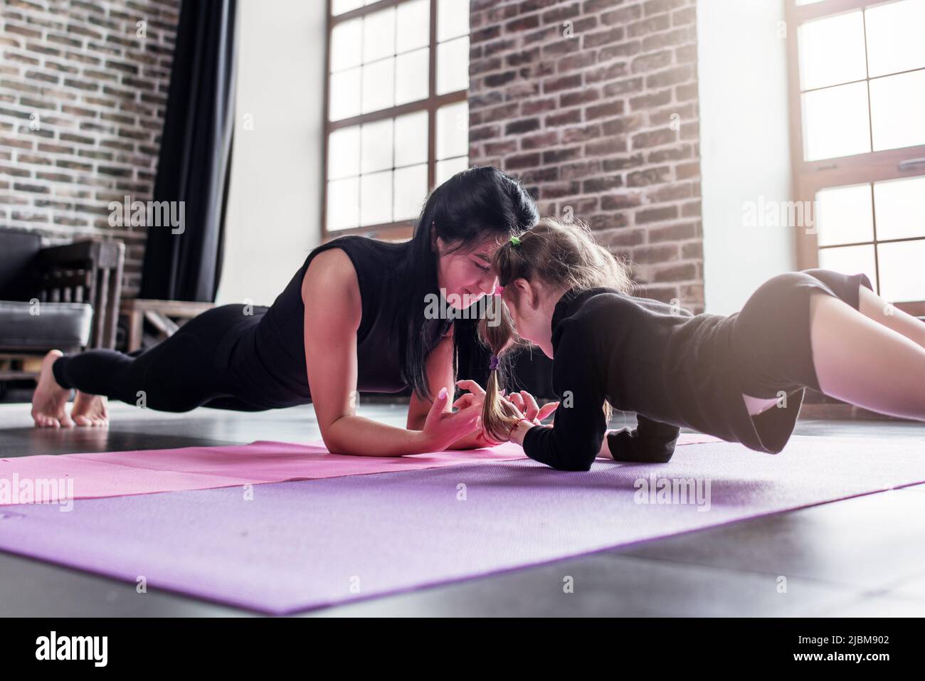 Mother and daughter working out together doing plank exercise in sports club Stock Photo - Alamy