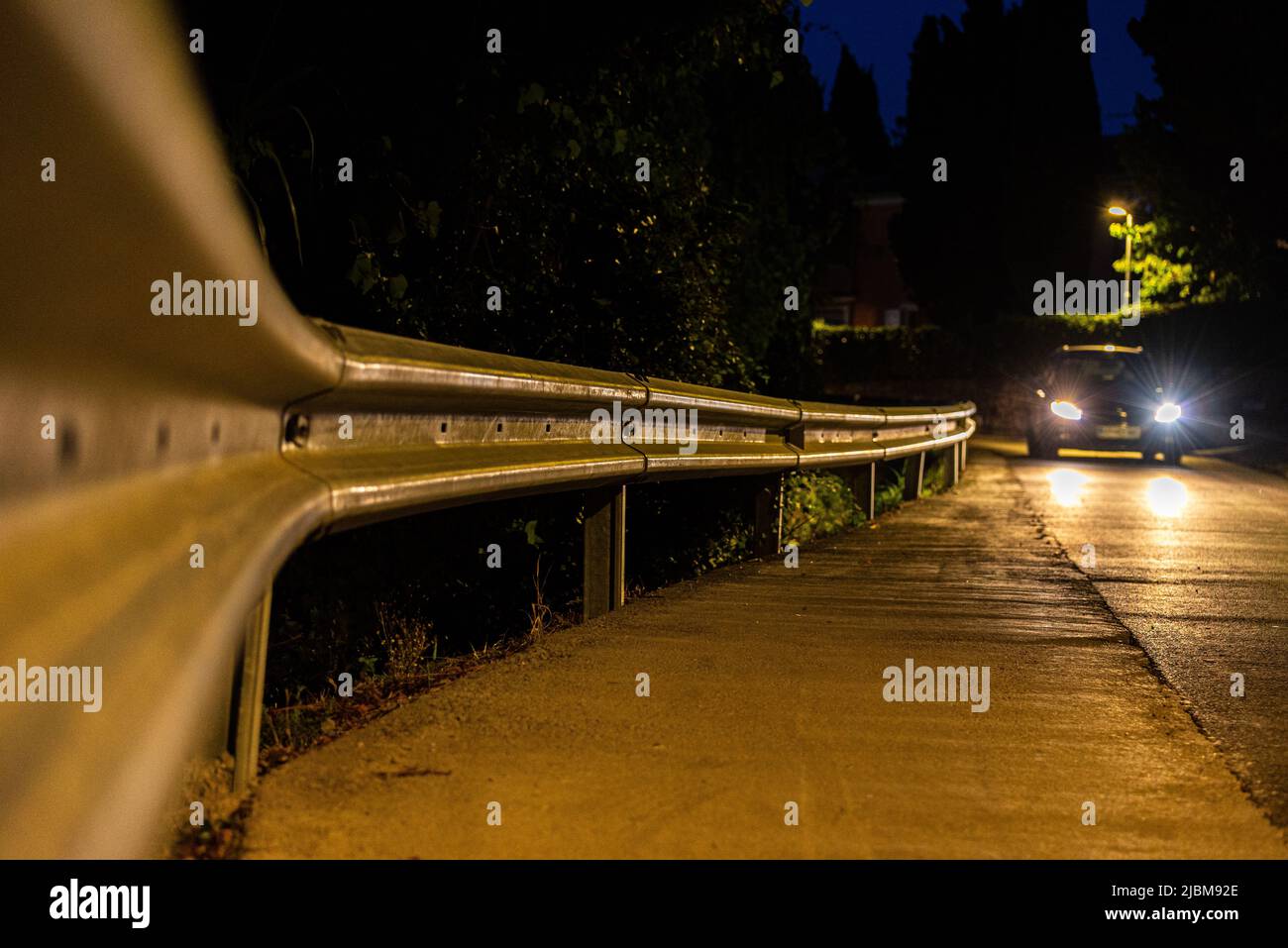 Dramatic shot taken from Road railing edge featuring car on concrete ...