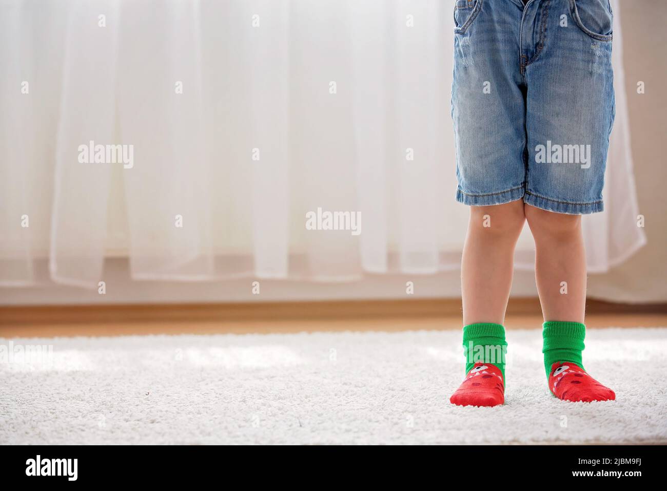 Child feet with different socks standing in rows, kids wearing ...