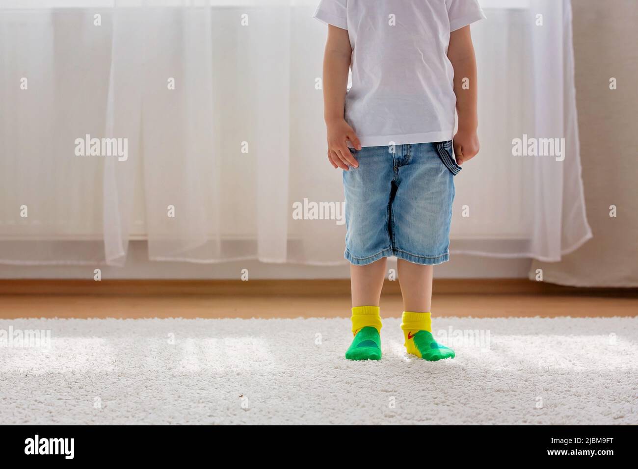 Child feet with different socks standing in rows, kids wearing ...