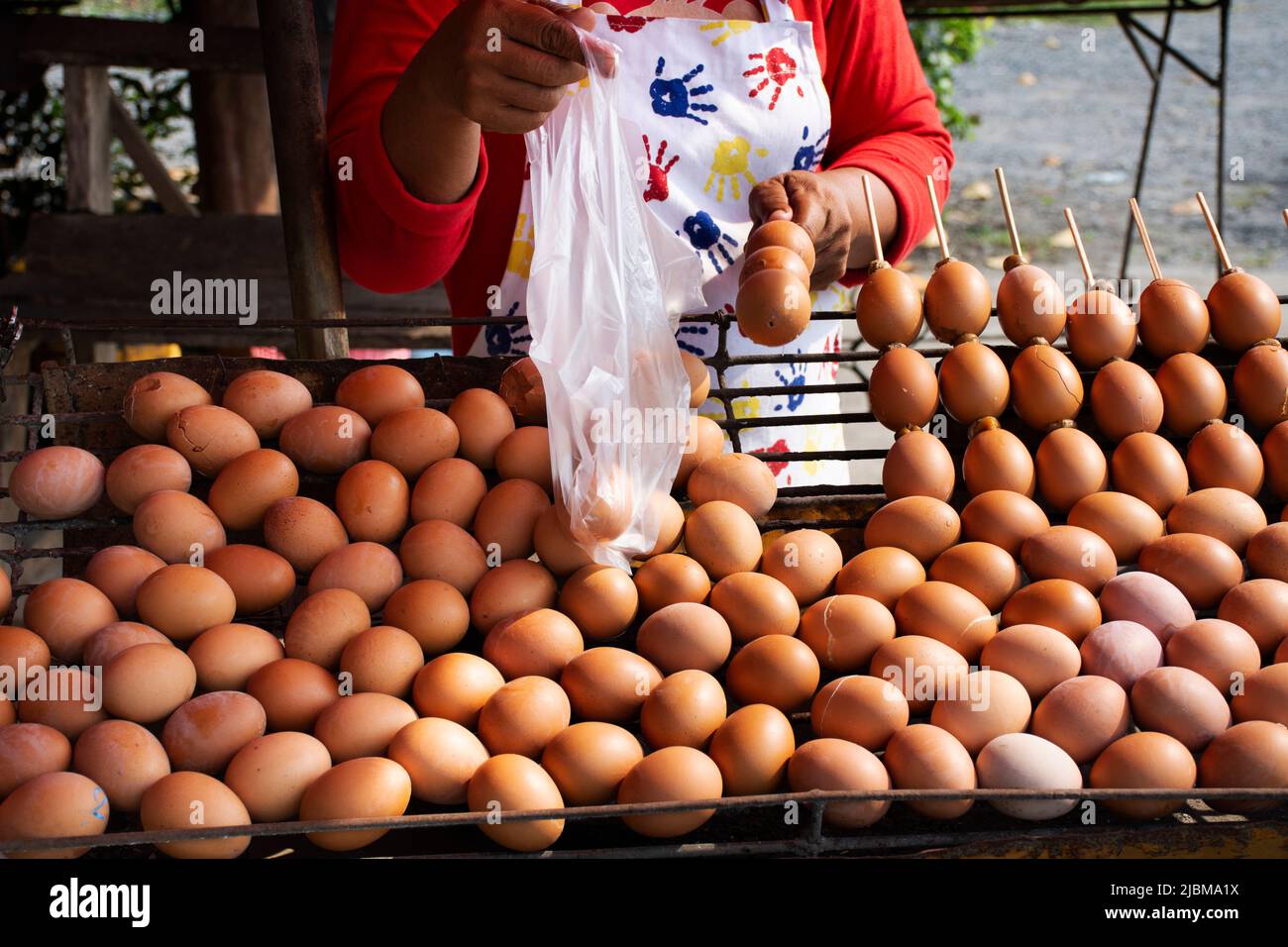 Egg scrambled mix with seasoning on antique old stove for grilled or ...