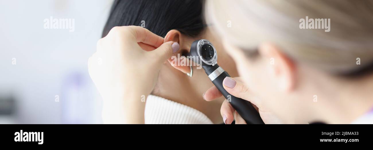 Close-up of female otolaryngologist examining ear with Stock Photo - Alamy