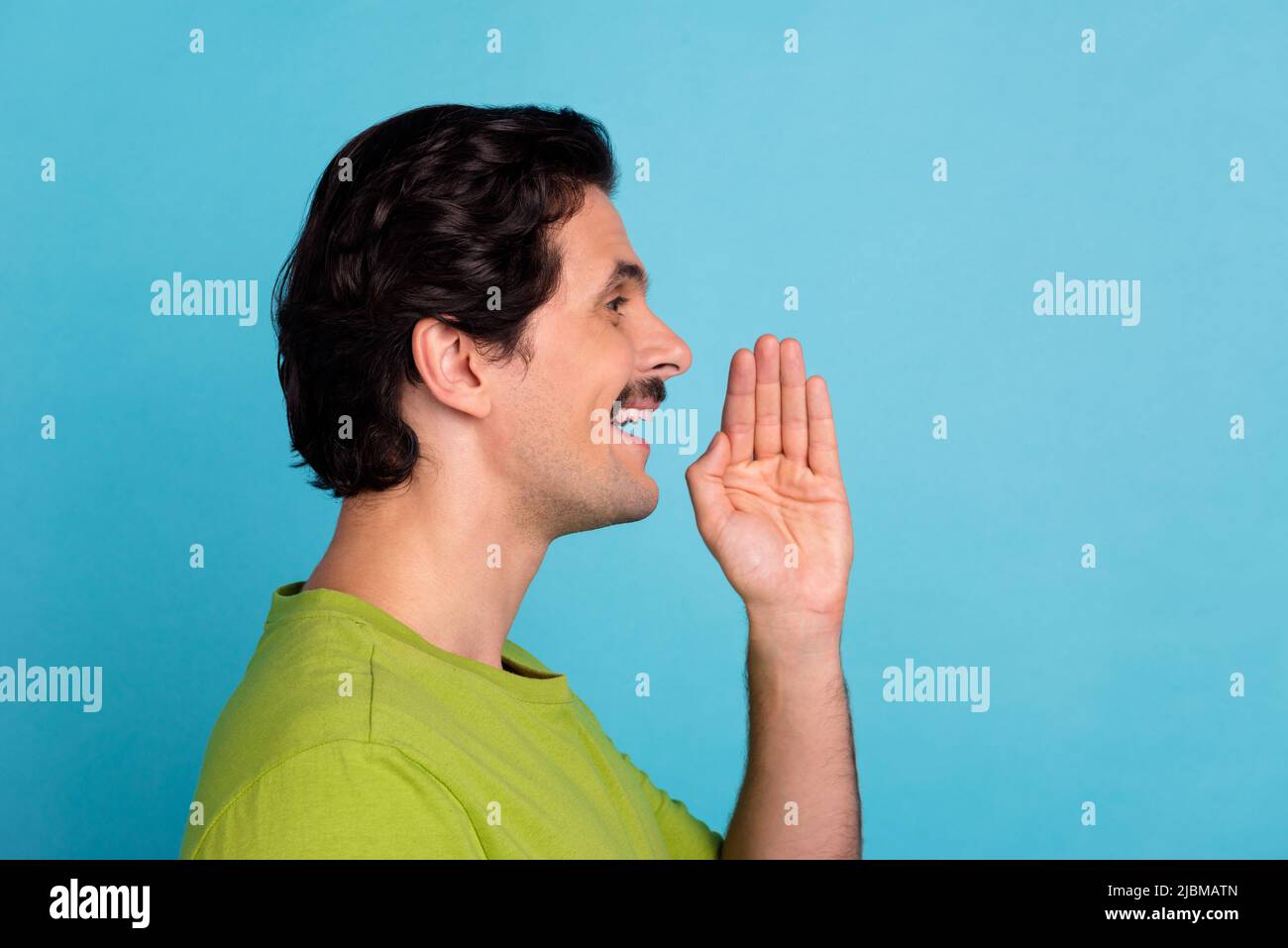 Photo of handsome excited man wear green t-shirt looking empty space ...