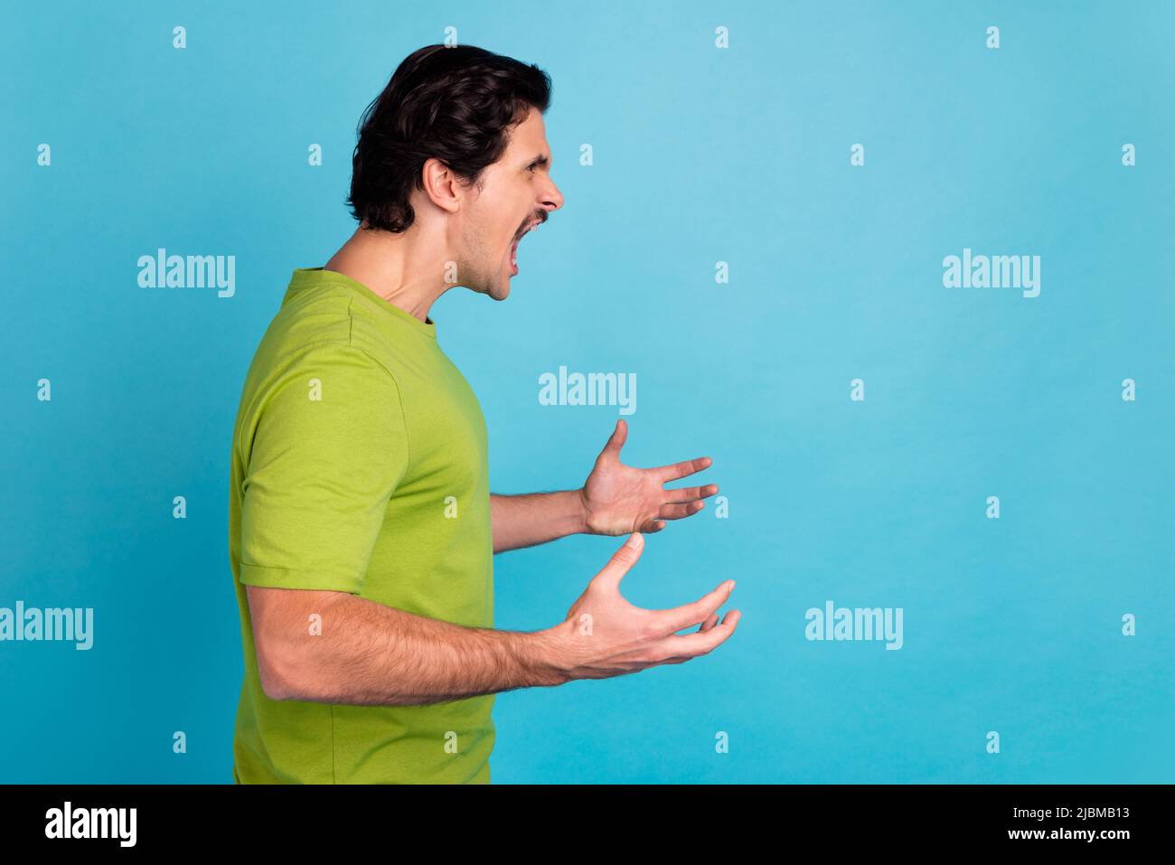 Photo of shocked angry man wear green t-shirt looking empty space ...