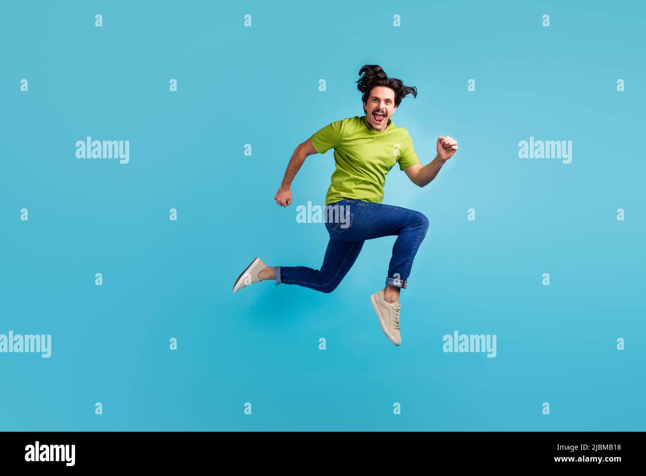 Full length photo of purposeful funky guy dressed green t-shirt jumping ...