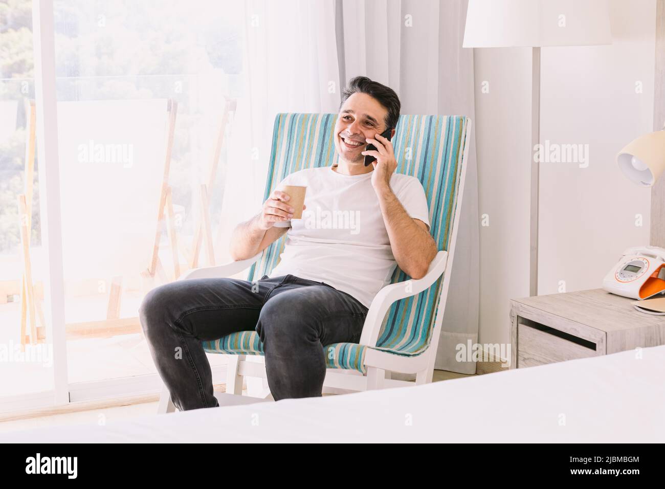 Man sitting on rocking chair hi-res stock photography and images - Alamy
