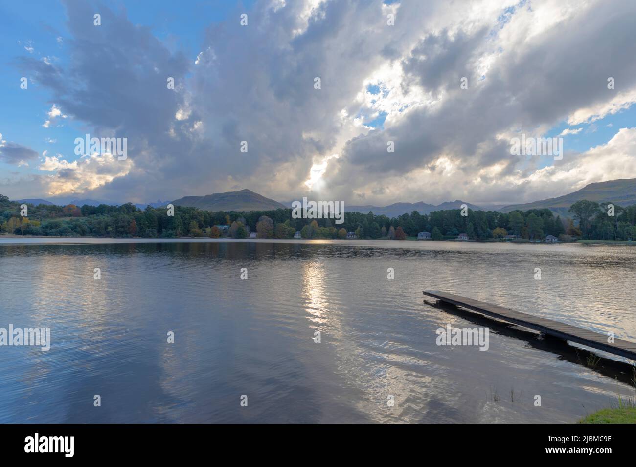 Wooden jetty into the lake with clouds above at Lake Naverone ...